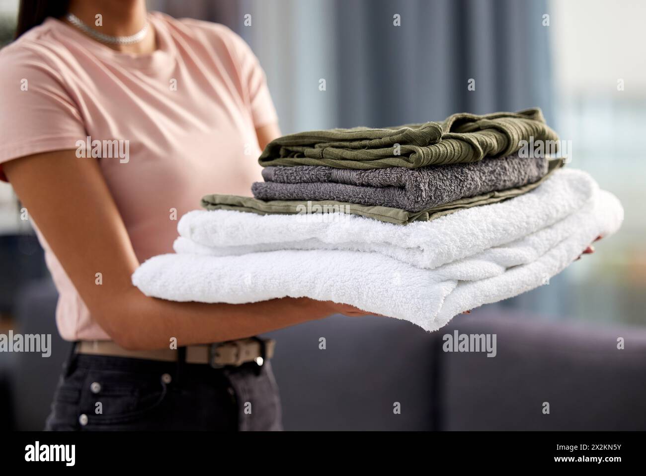 Home, clean laundry and woman with closeup, linen and hospitality with ...