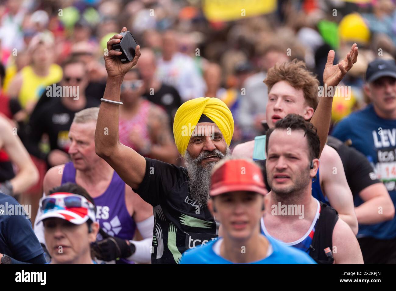 Asian runner participating in the TCS London Marathon 2024 passing ...