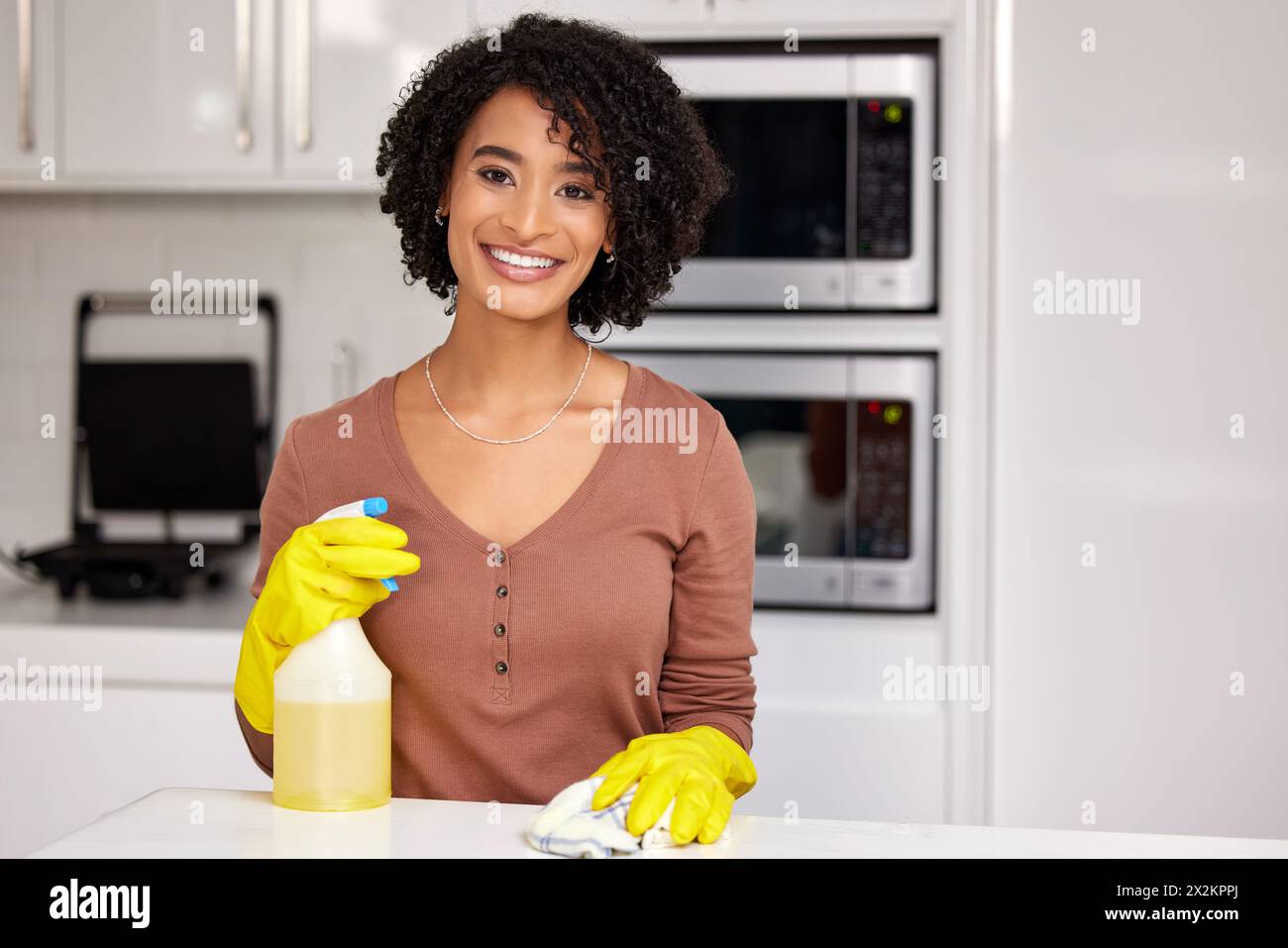 Black woman, portrait and cleaning counter in kitchen, wipe glass and ...