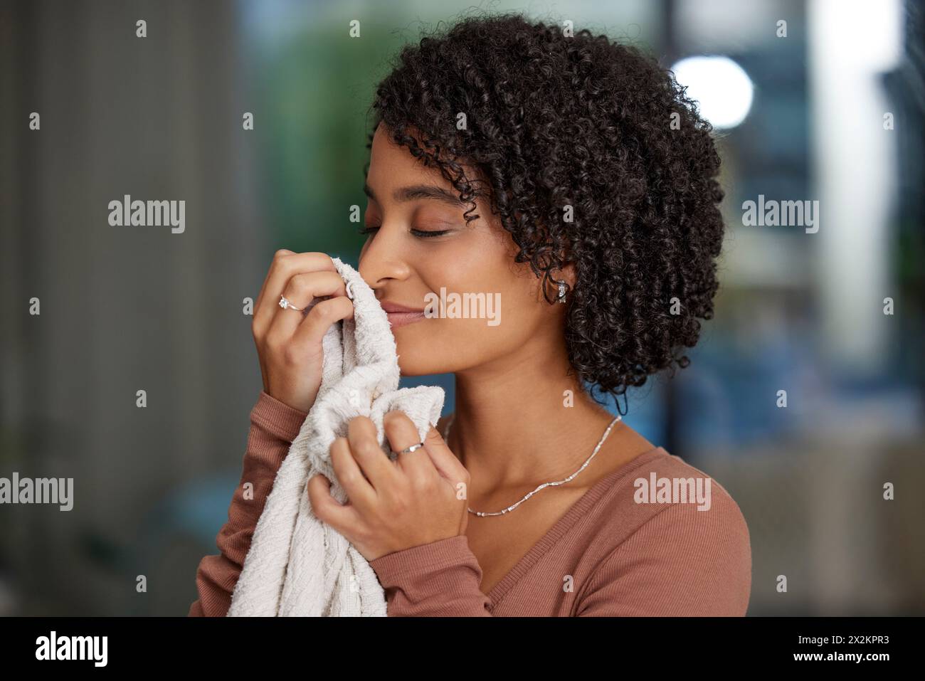 Clean, towel and woman with smelling in home for fresh aroma ...