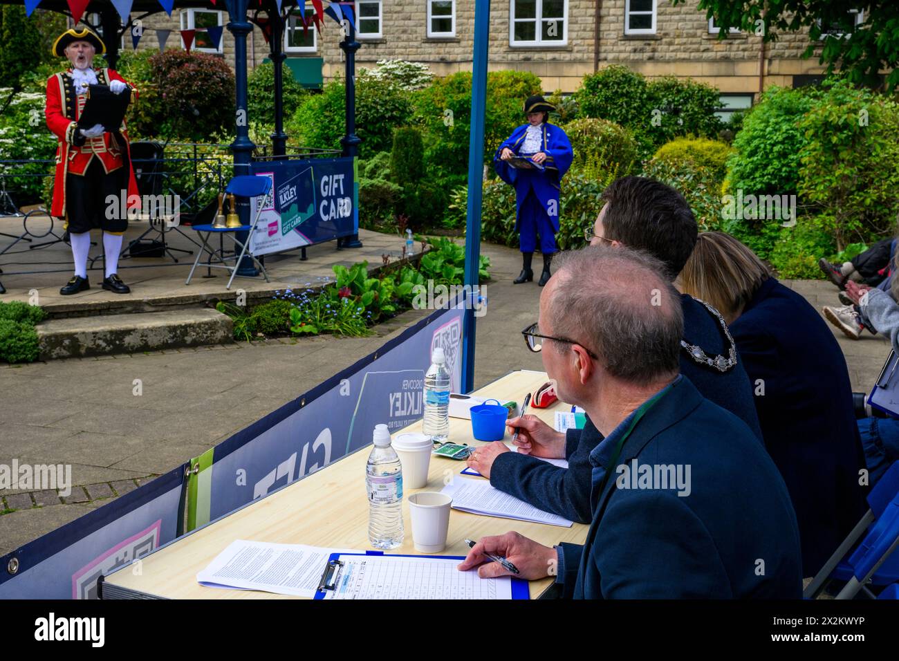 Male town crier (colourful red braided crier's livery) proclaiming ...
