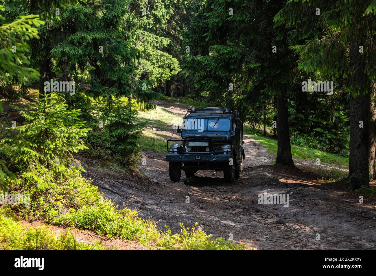 Old retro vintage 4x4 SUV on a dirt gravel dirt road in summer. Off ...