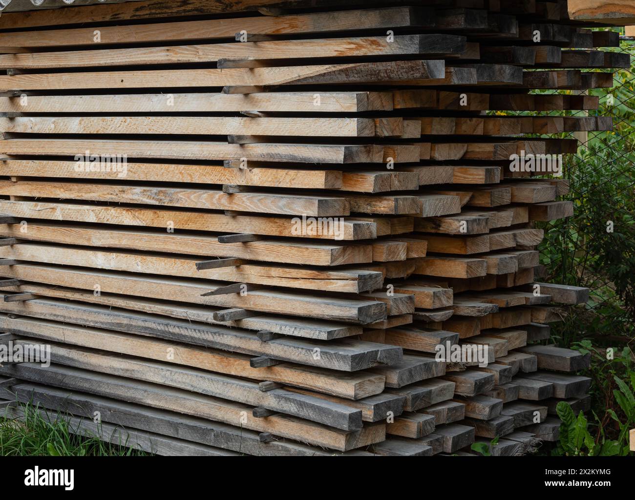 Piles of wooden boards in the sawmill, planking. Warehouse for sawing ...