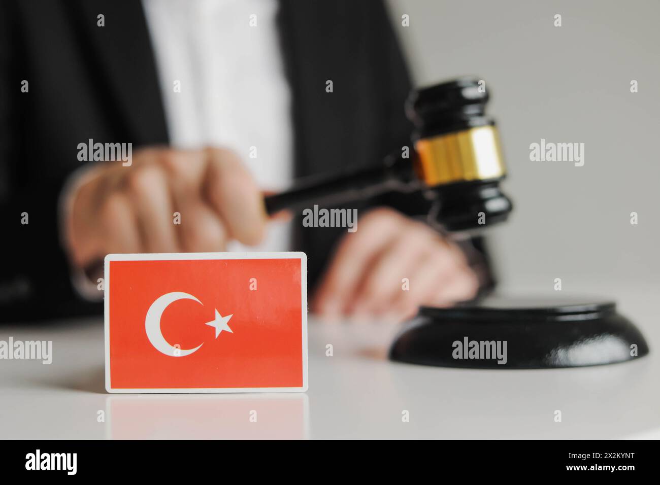 Judge's hand holding wooden gavel. Flag of Turkey. Sanctions in Turkey ...