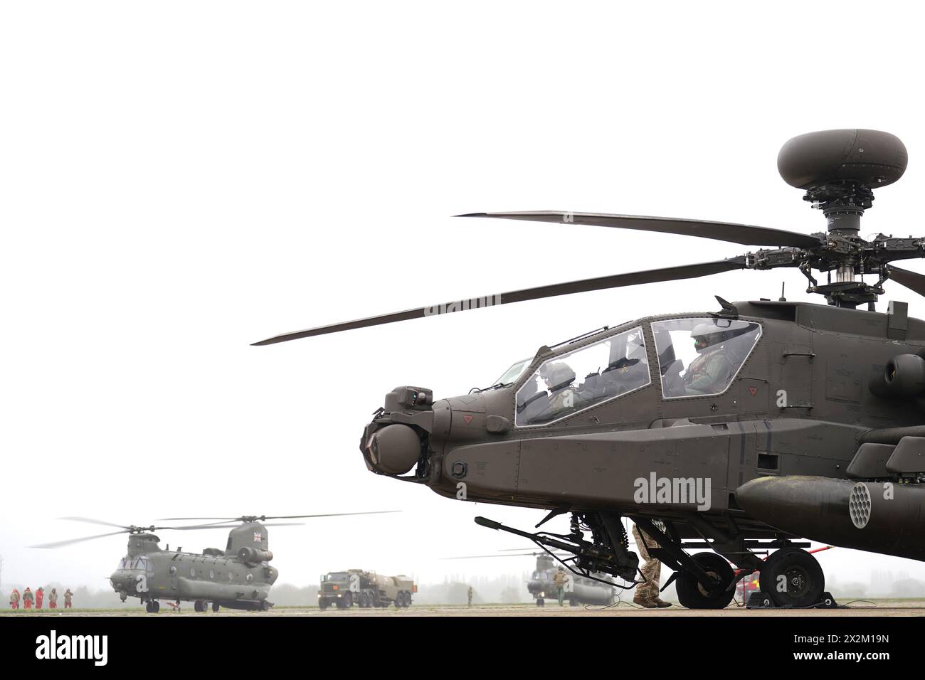 British Army Apache AH-64E attack helicopters (right) are prepared for ...