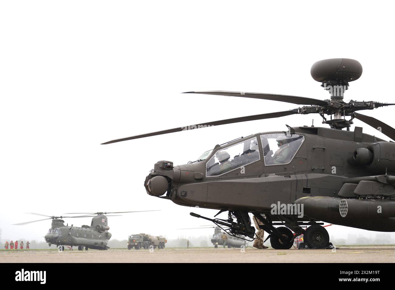 British Army Apache AH-64E attack helicopters (right) are prepared for ...