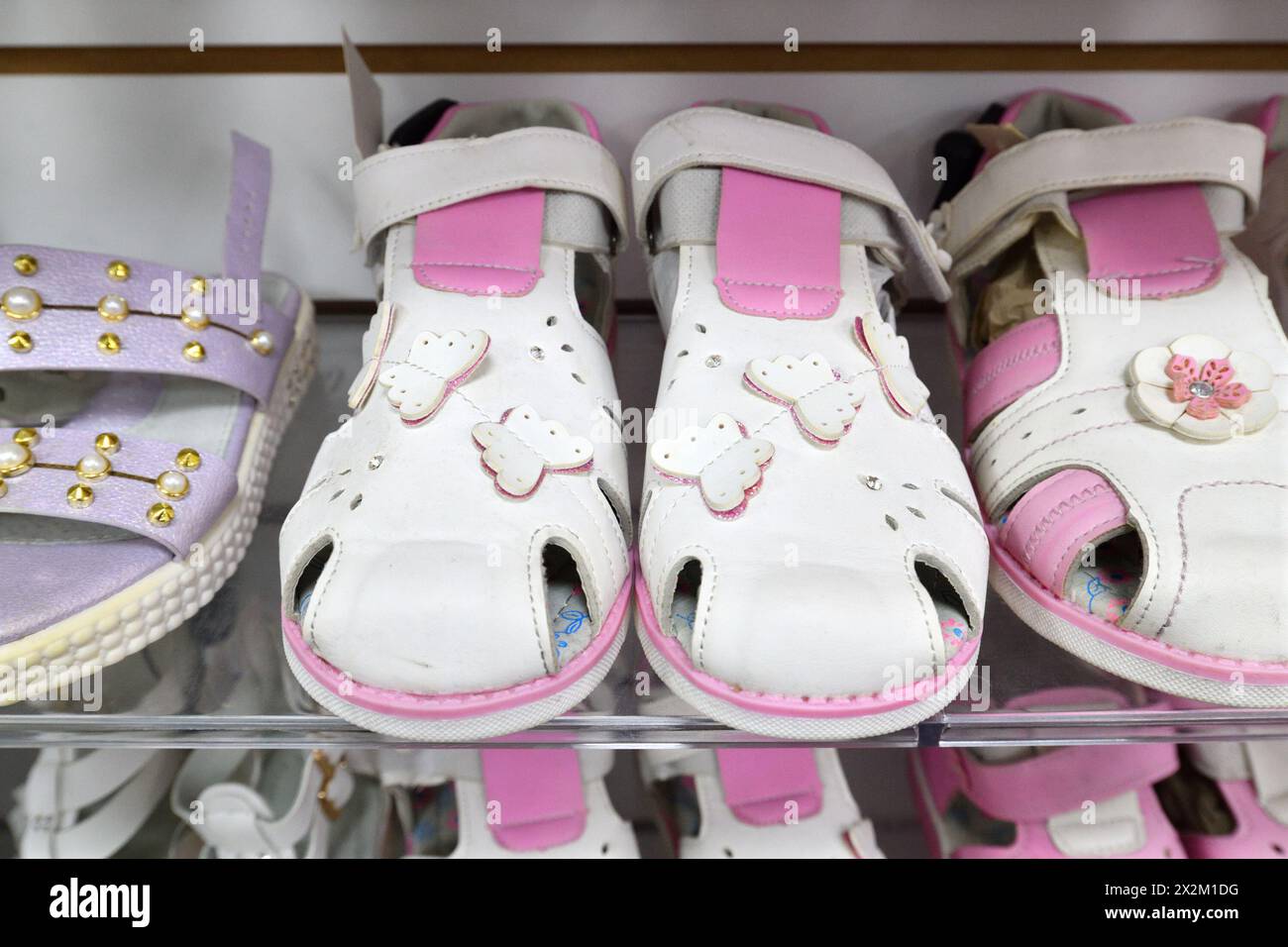 Children's Shoes on store counter Stock Photo - Alamy