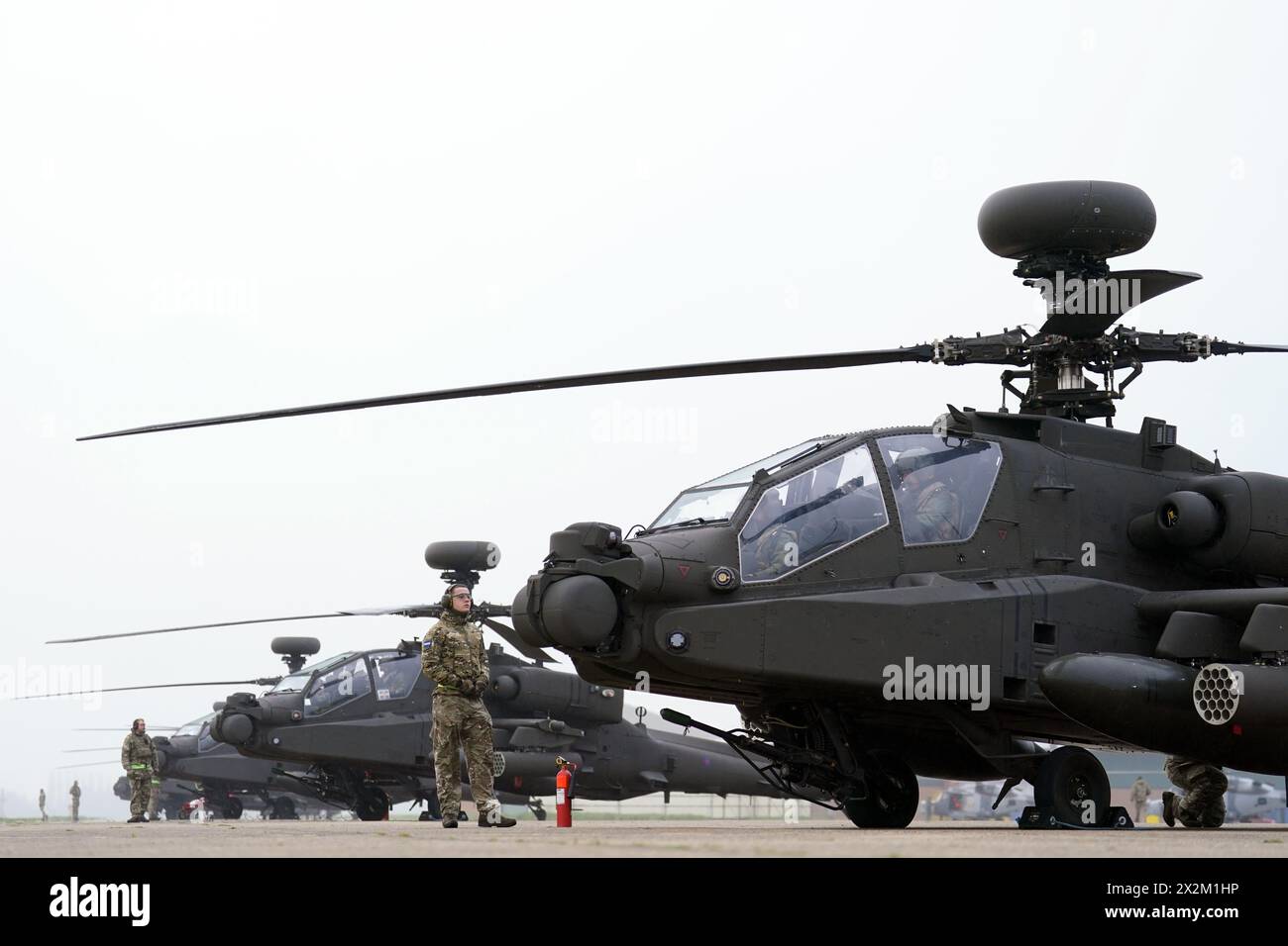 British Army Apache AH-64E attack helicopters (right) are prepared for ...