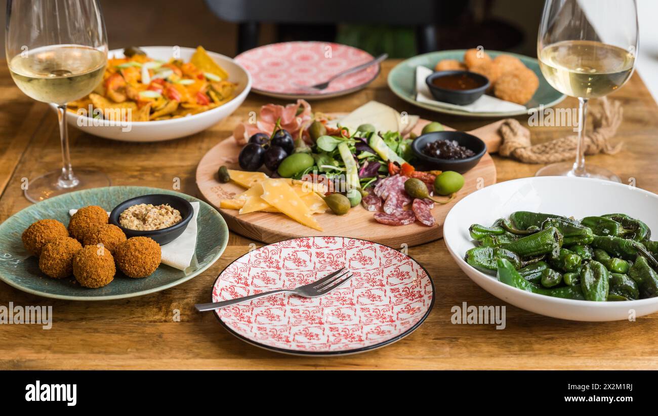 A mixed selection of tasty bites, nibbles and appetizers with white ...