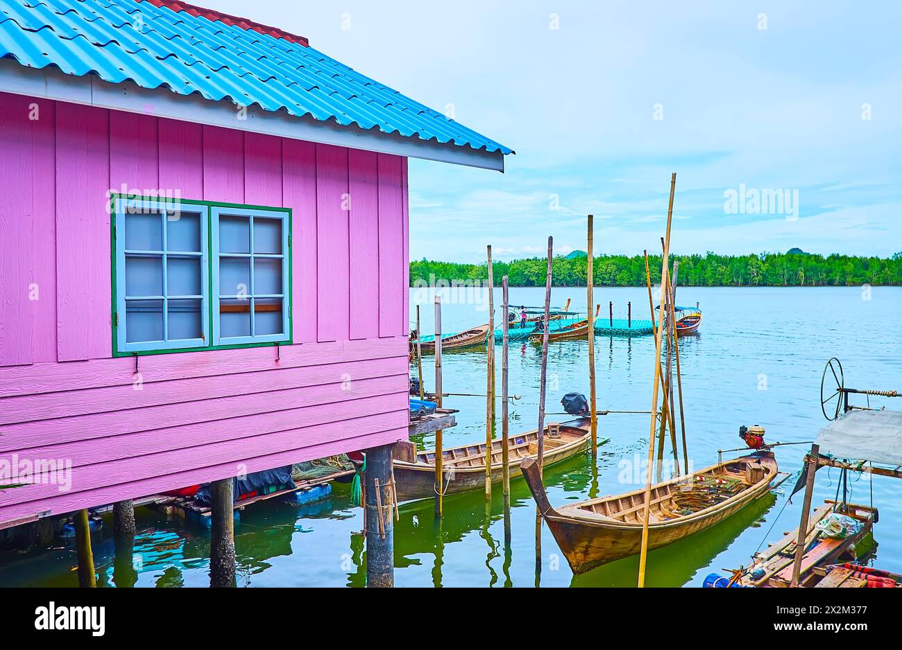 The old kayak boats are moored at the colored wooden stilt house of Ko ...