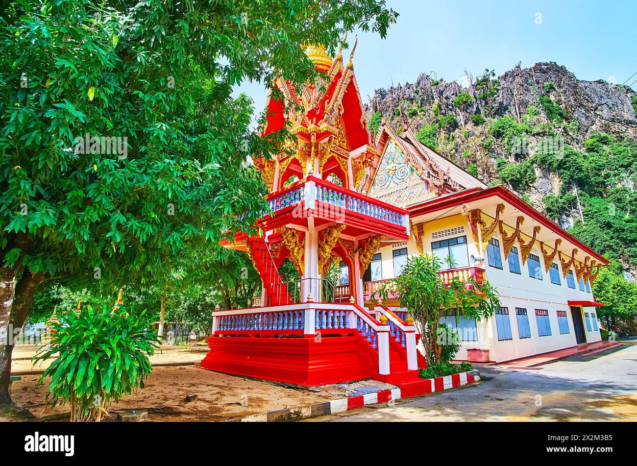 Impressive bright red Ho Rakang belfry of Wat Suwan Kuha Cave Temple ...