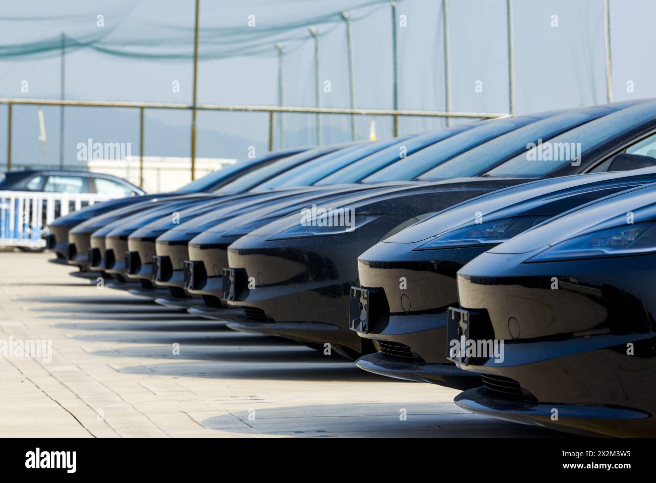 A row of brand new new energy electric cars parked in an outdoor ...