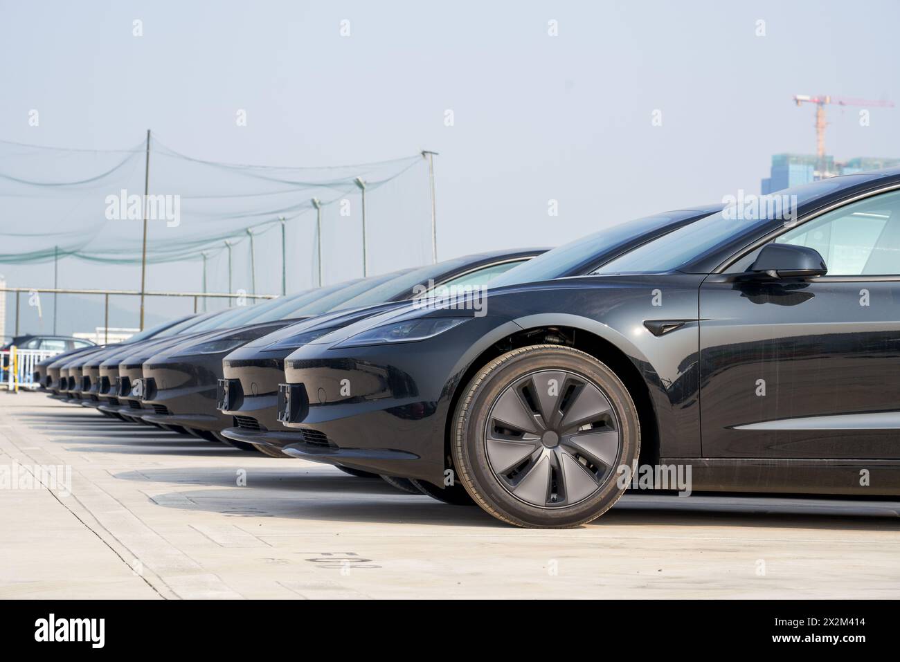 A row of brand new new energy electric cars parked in an outdoor ...