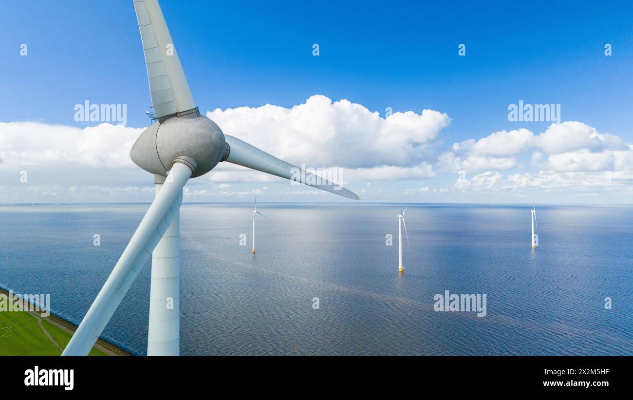 A mesmerizing view of wind turbines gracefully spinning in the ocean ...