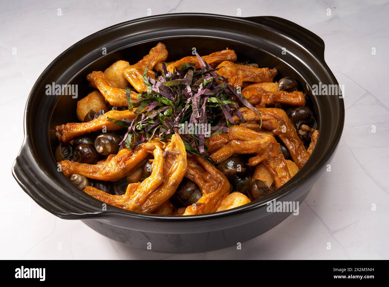A pot of delicious and fragrant screws, snails and duck feet in a pot ...
