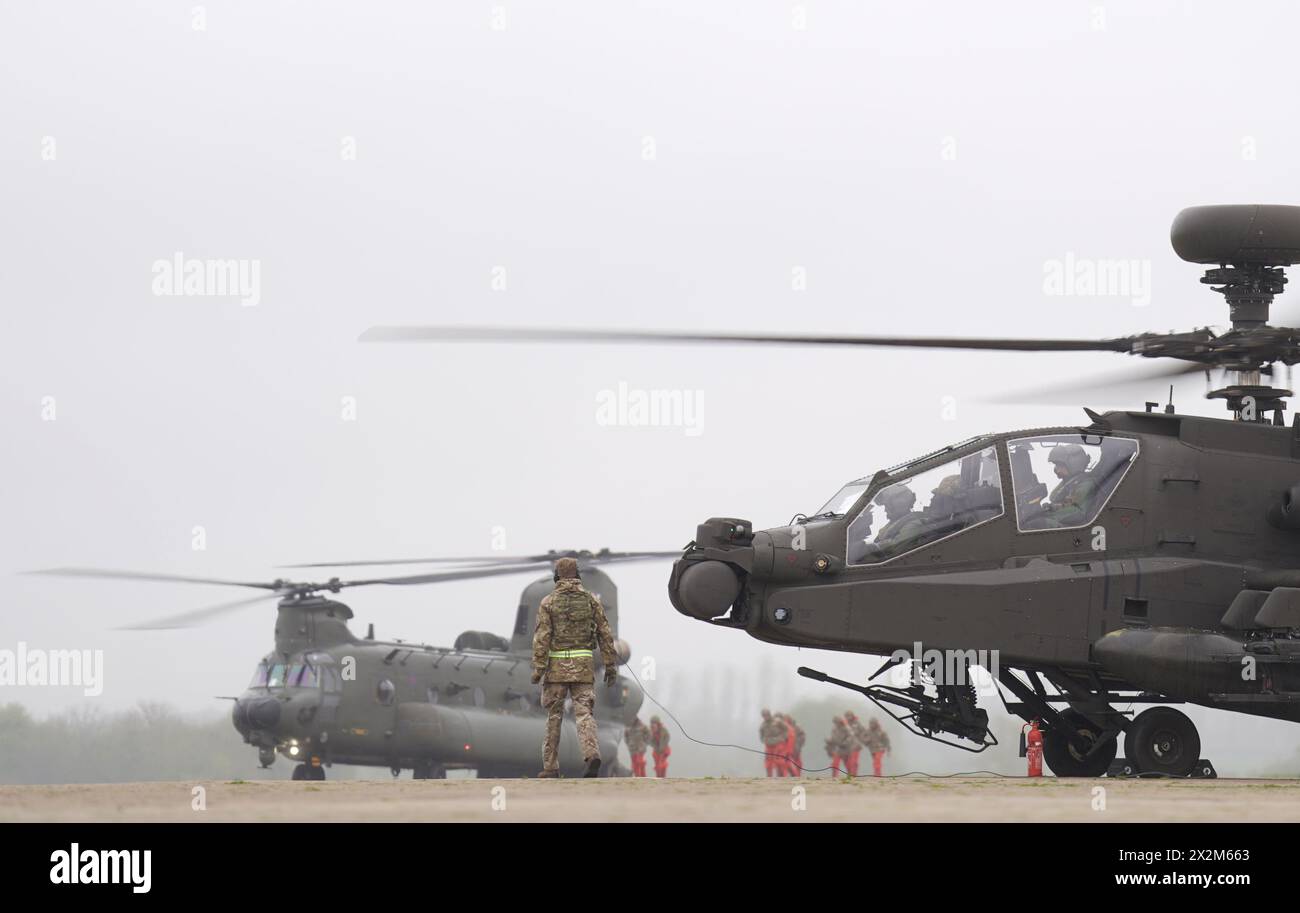 British Army Apache AH-64E attack helicopters (right) are prepared for ...