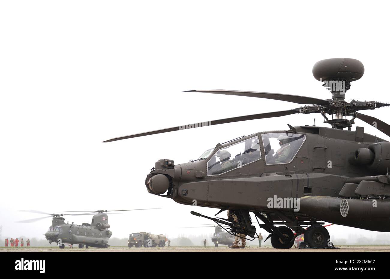 British Army Apache AH-64E attack helicopters (right) are prepared for ...