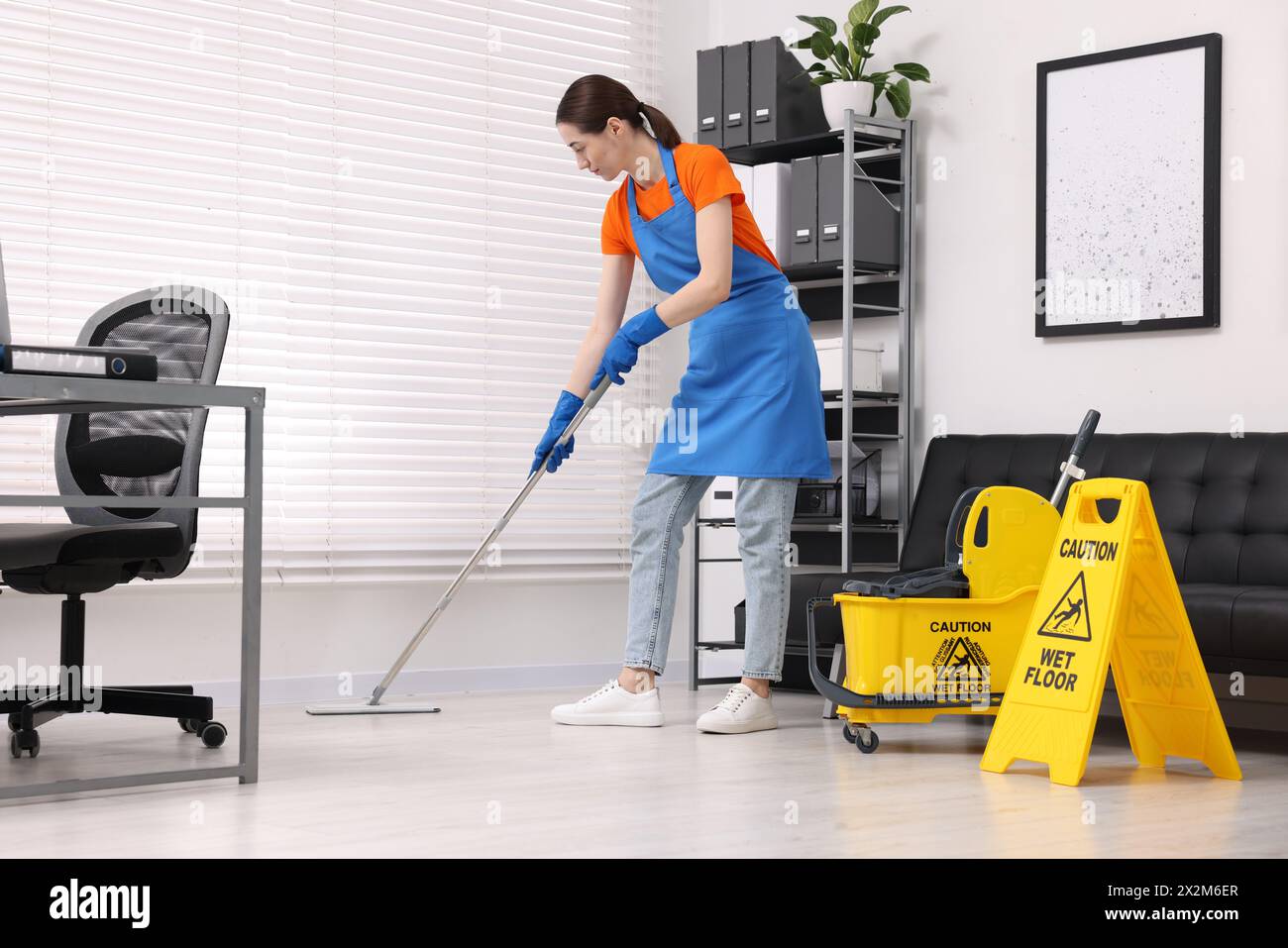 Cleaning service. Woman washing floor with mop in office Stock Photo ...