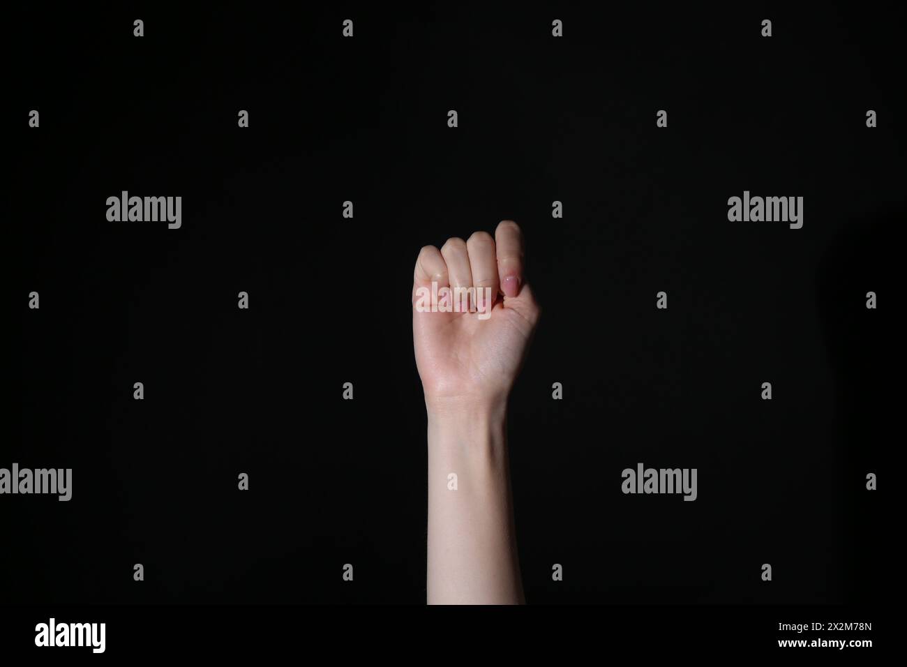 SOS gesture. Woman showing signal for help on black background, closeup ...