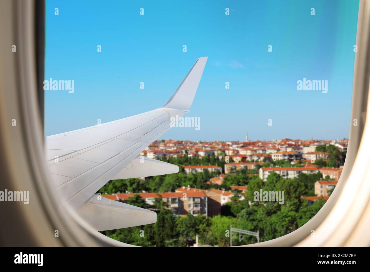 Beautiful city with buildings, view through airplane window during ...