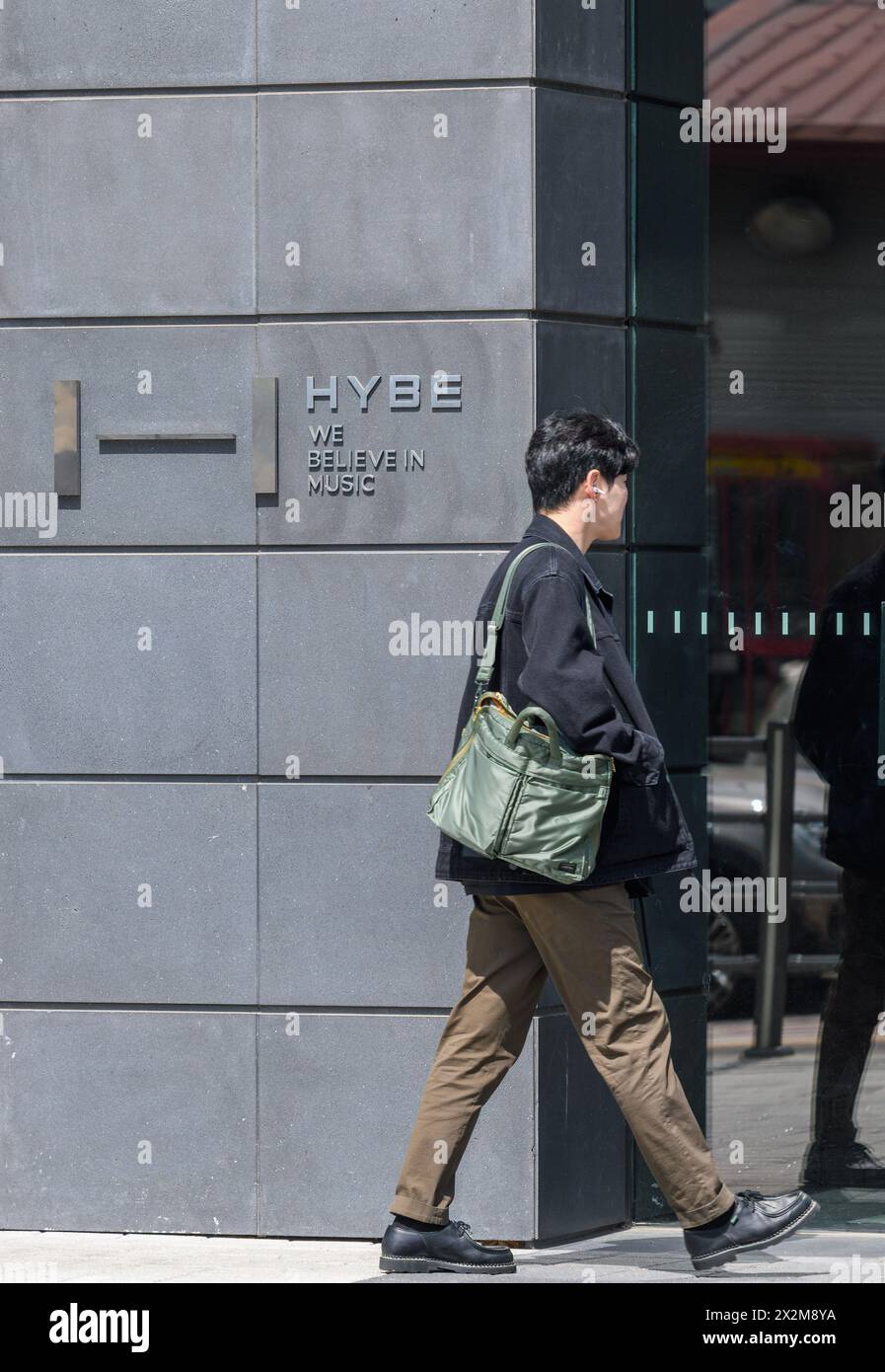 Seoul, South Korea. 23rd Apr, 2024. A man walks past the Hybe Building ...
