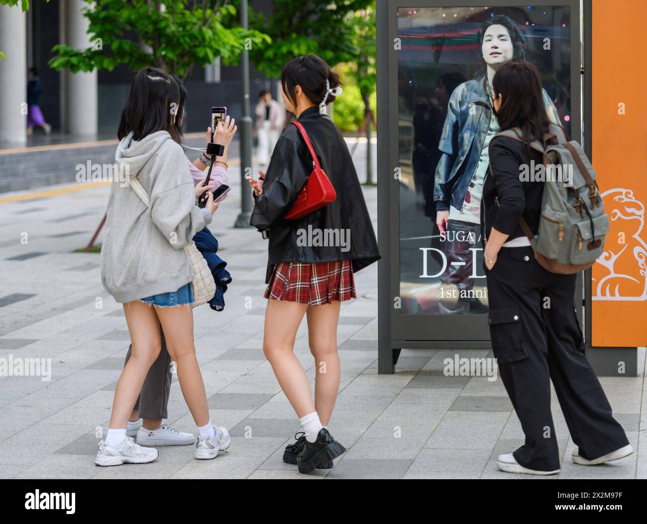 K-pop fans take pictures of a billboard of Hybe's singer SUGA of BTS in ...