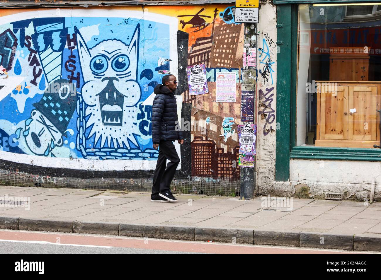 Bristol, England- March 30, 2024: Young man walking on the street in ...
