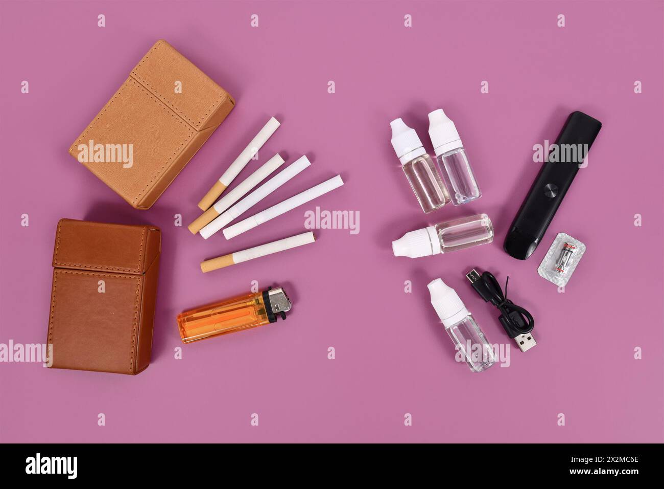 Comparison between electronic and real cigarette with tools on violet ...