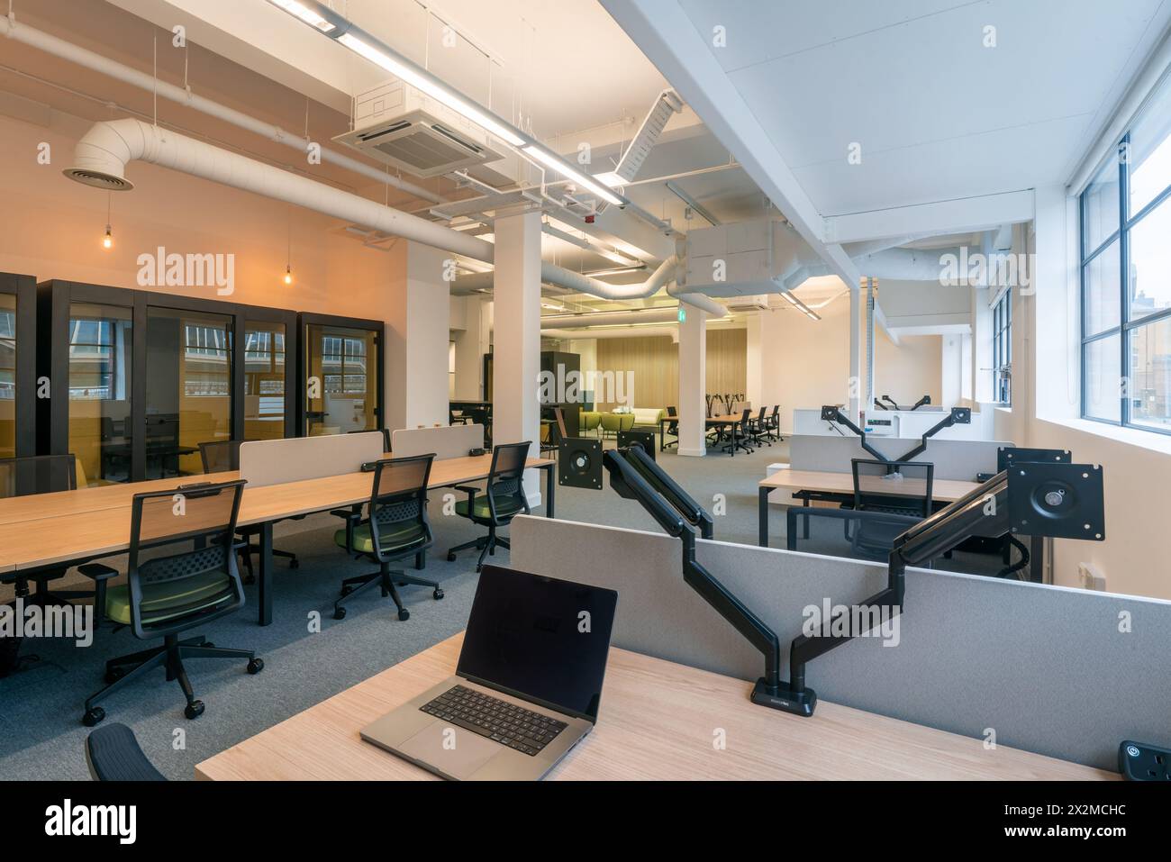 A bright and spacious office featuring an open-plan layout with ...