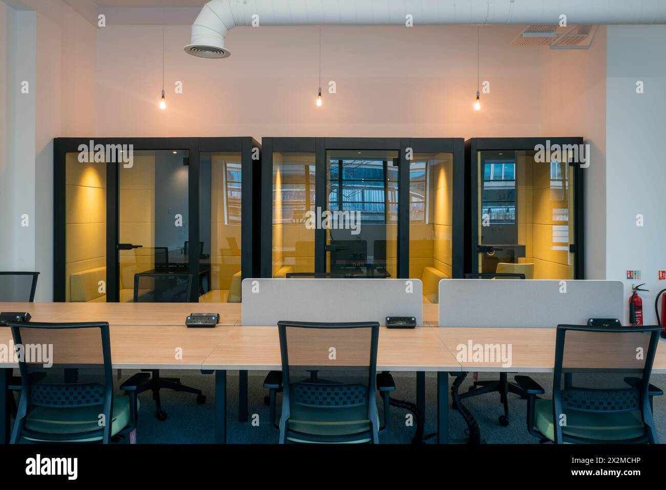 A contemporary office space features individual workstations with ...