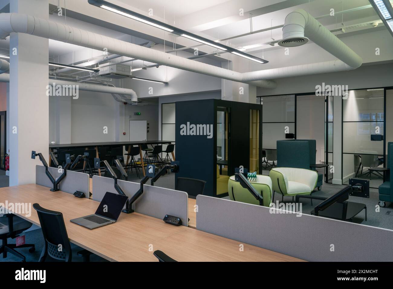 A modern office space equipped with ergonomic furniture, computers, and ...