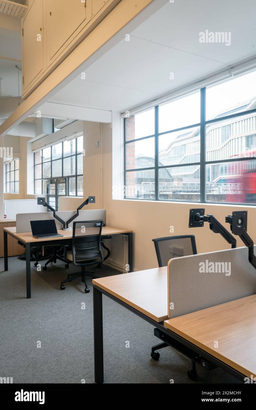 Contemporary office space with ergonomic chairs, adjustable desks, and ...