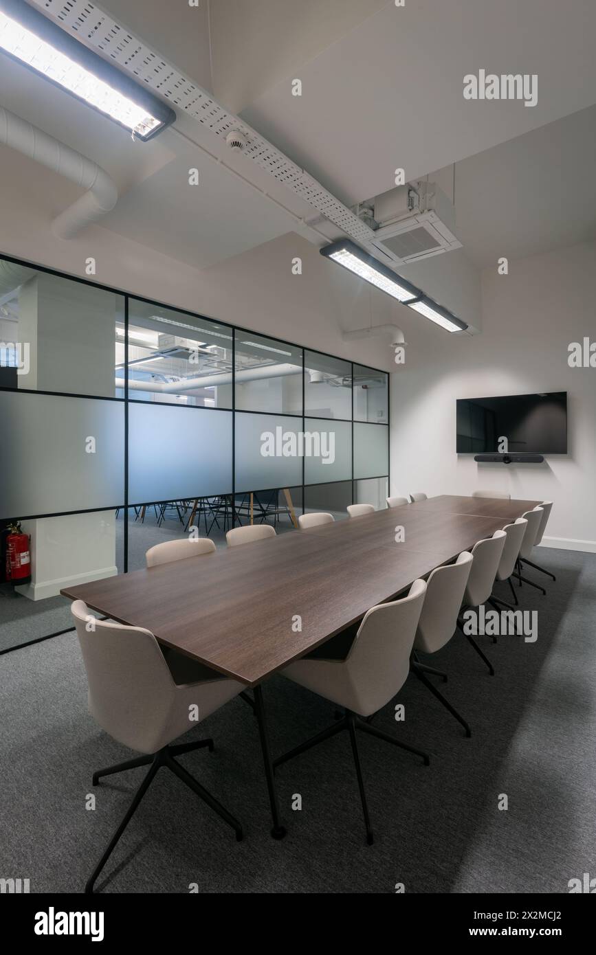 Contemporary conference room featuring a large wooden table, white ...