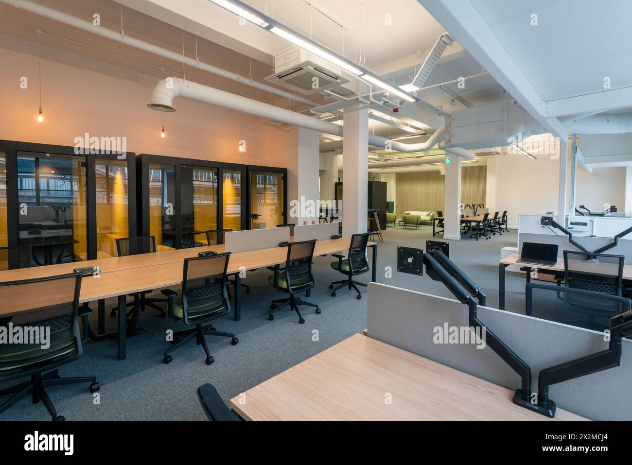 Spacious modern office featuring an open floor plan with well-spaced ...