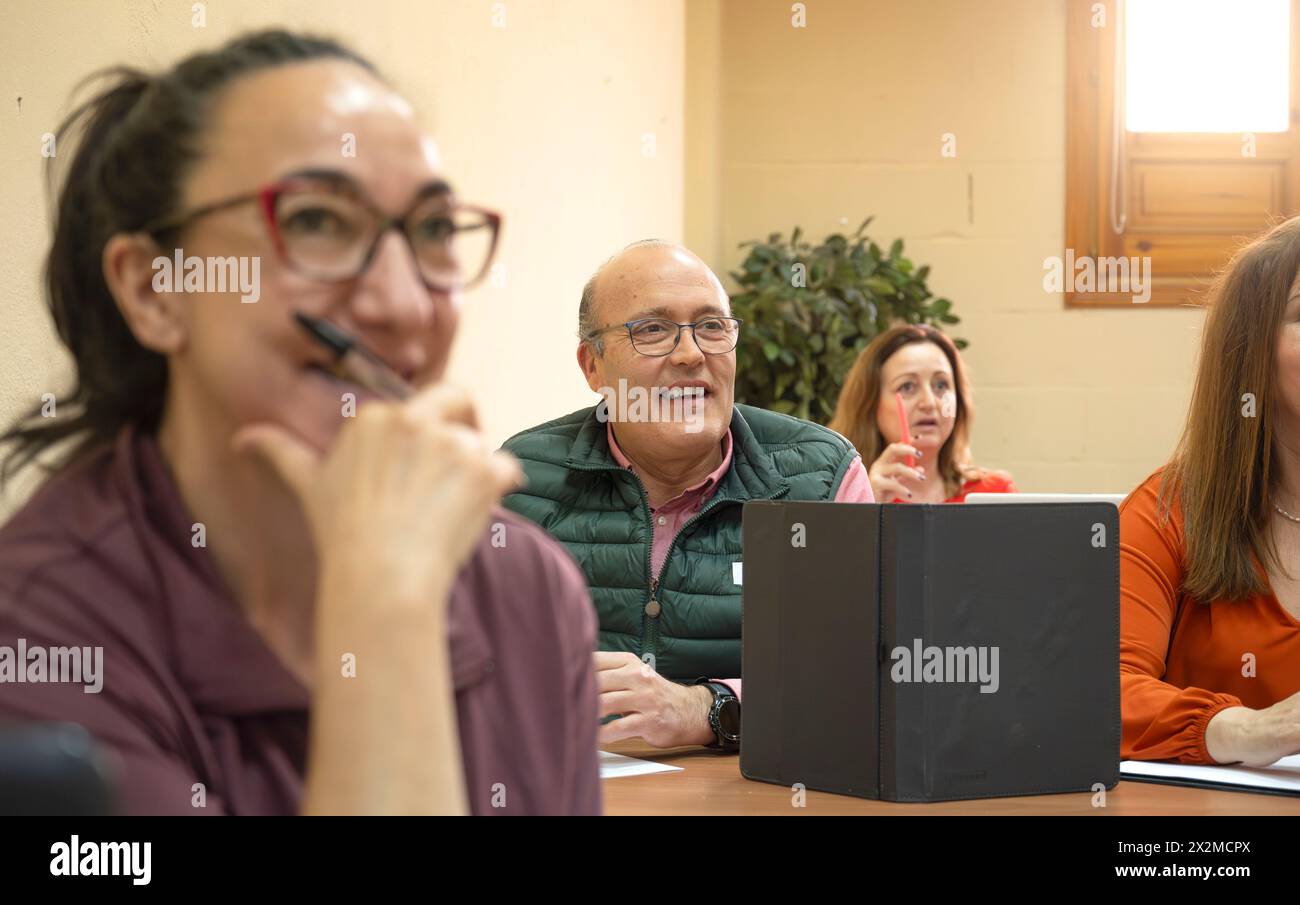 A diverse group of senior adults are focused and participating in a ...