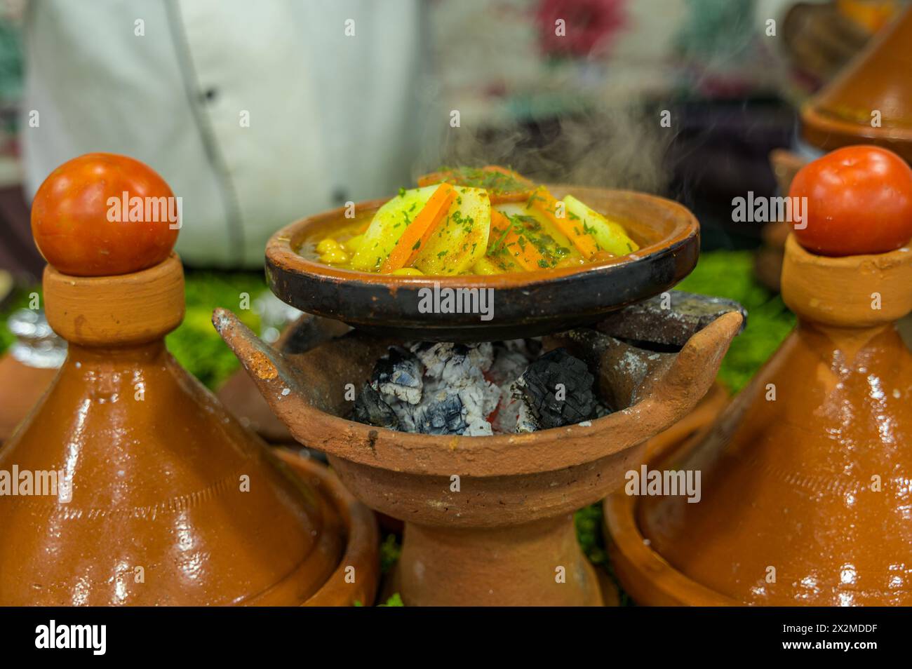 A typical Moroccan tagine dish is shown here, simmering over hot coals ...