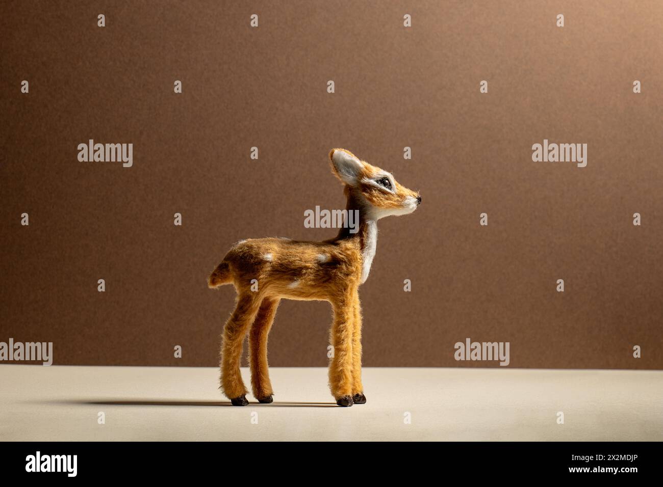 Handcrafted felted wool deer in a studio setting with a brown ...