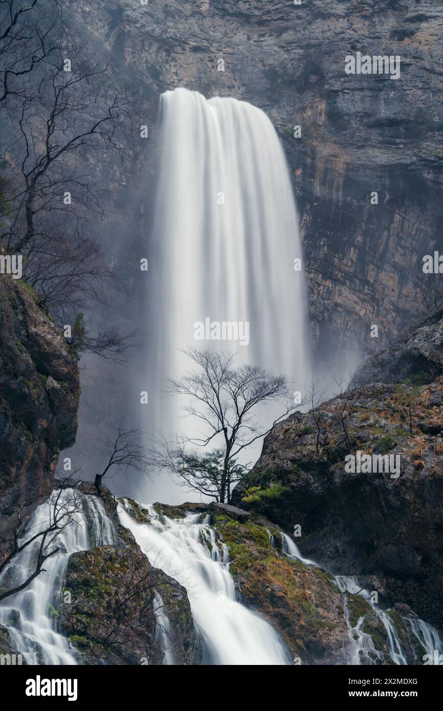 The powerful cascade of the Rio Mundo Reventón flows amidst the rocky ...