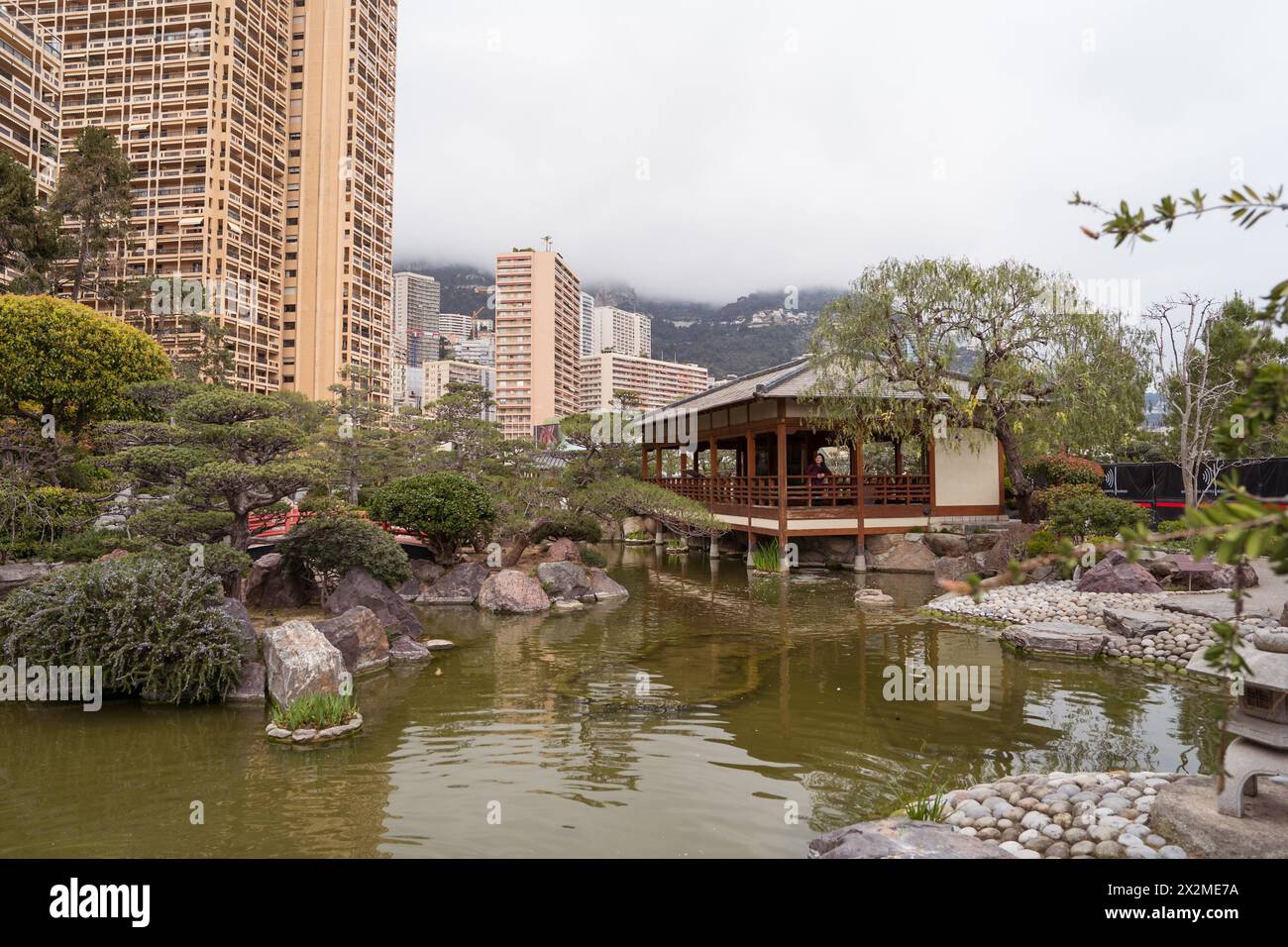 A serene Japanese garden with lush greenery and a peaceful pond nestled ...