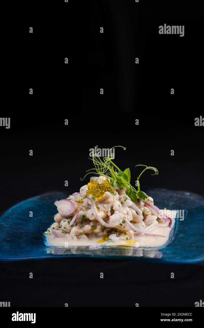 A tantalizing dish of shrimp ceviche garnished with fish roe, sprouts ...