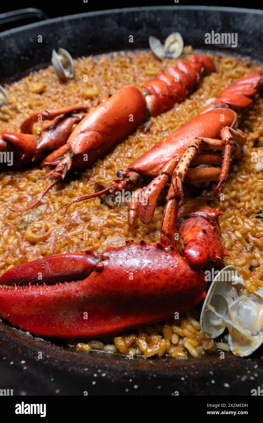 A perfectly cooked Valencian seafood paella with mussels, crab, squid ...