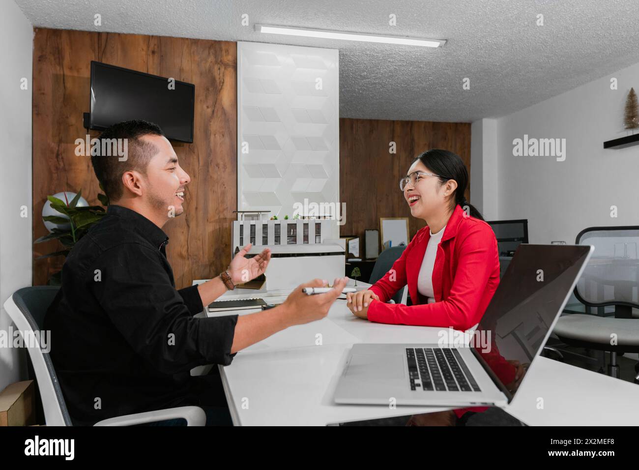 A positive work interaction between a Latin American male and female in ...