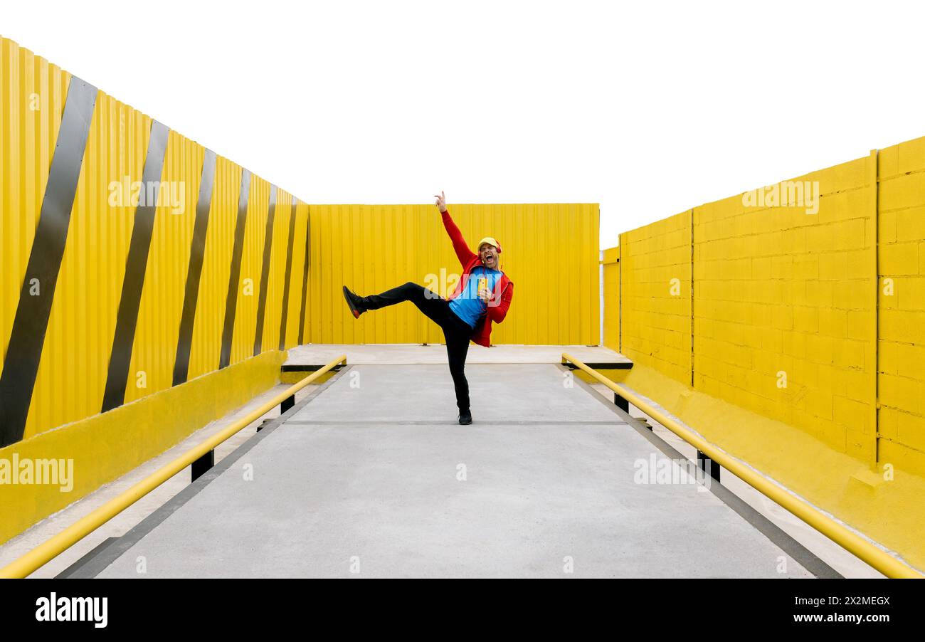An exuberant individual performs a dynamic dance move on a ramp ...