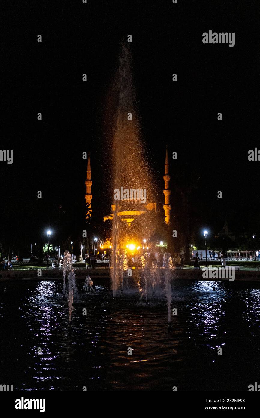 A night view of a fountain in front of Istanbul's Blue Mosque, also ...