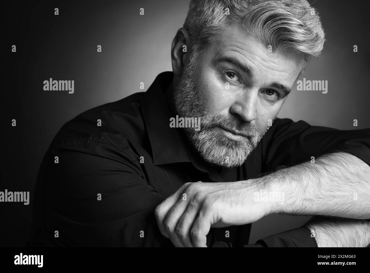 Portrait of handsome man on dark background. Black and white effect ...