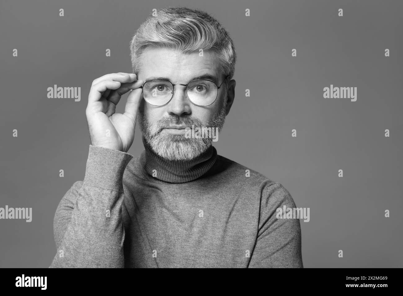 Portrait of handsome man on grey background. Black and white effect ...