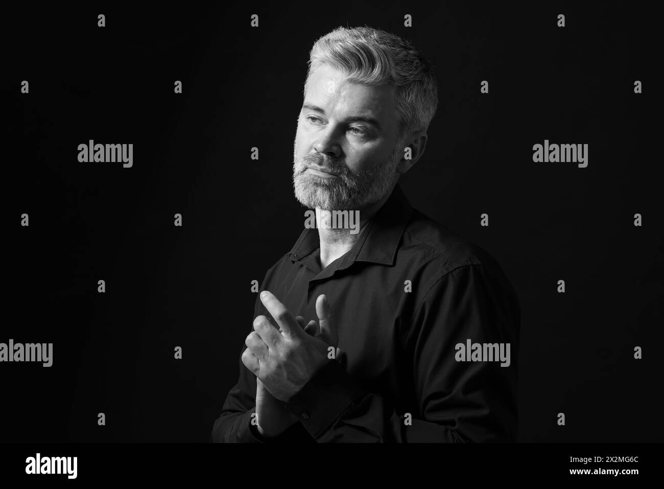 Portrait of handsome man on dark background. Black and white effect ...