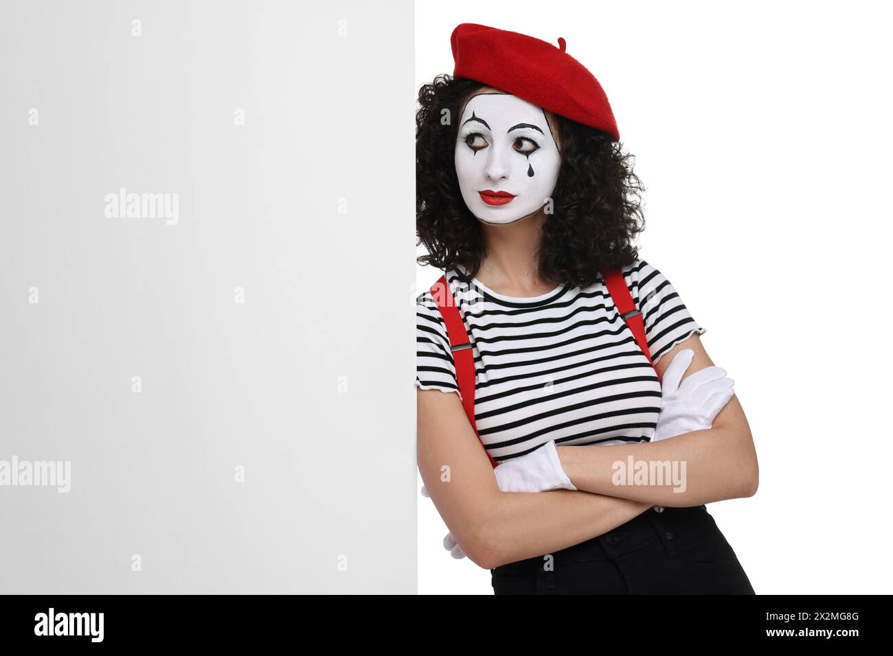 Funny mime with blank poster posing on white background Stock Photo - Alamy