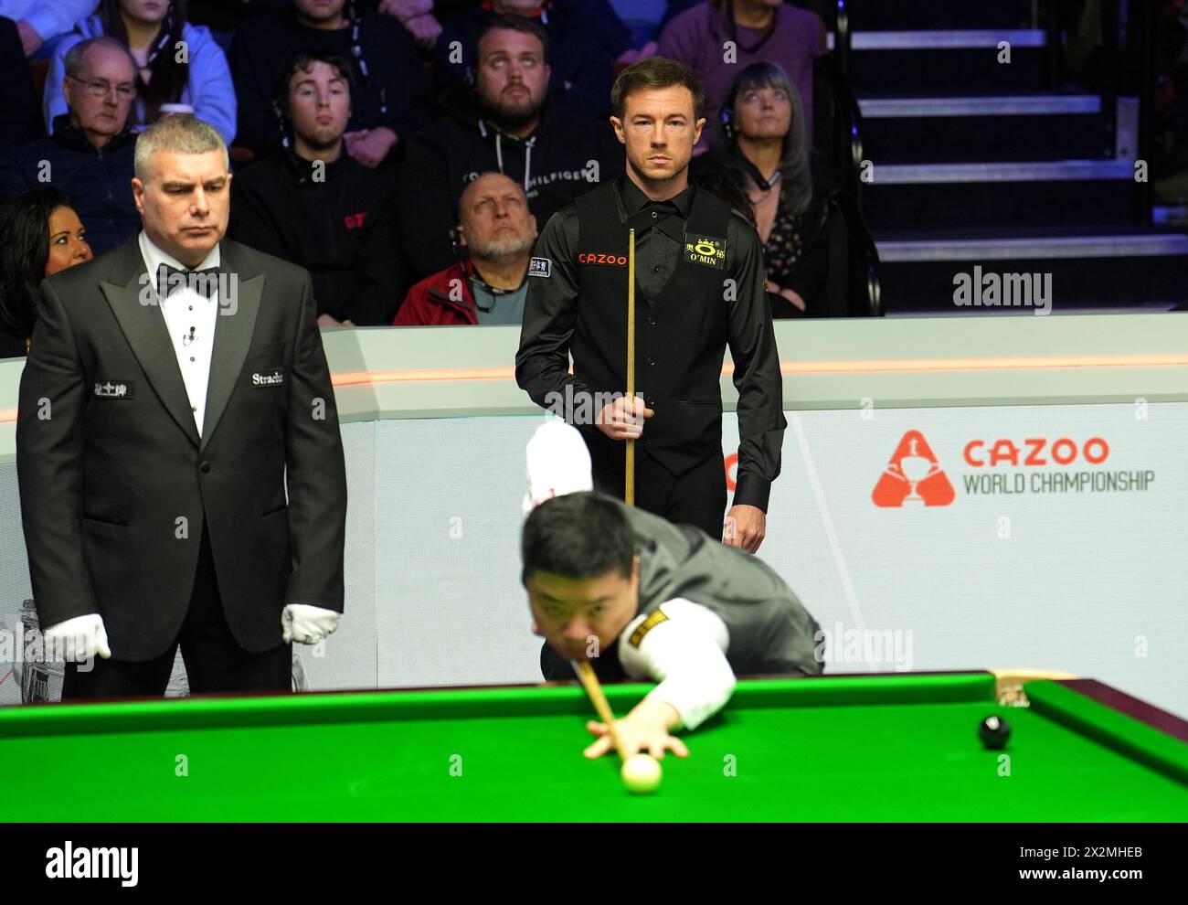 Jack Lisowski watches Ding Junhui in action on day four of the 2024 ...
