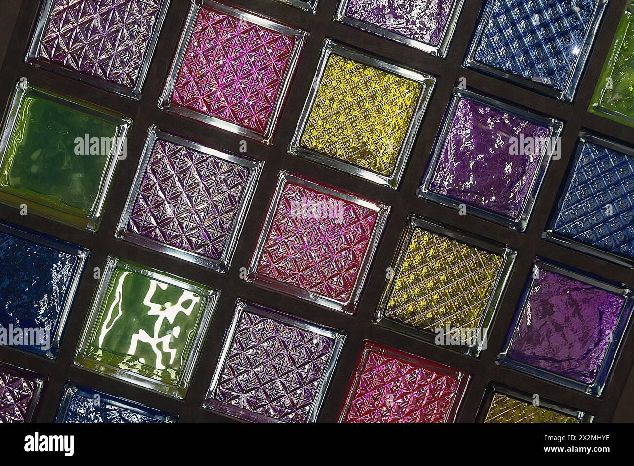 Multicolored glass stained glass blocks on exhibition stand. Interior ...